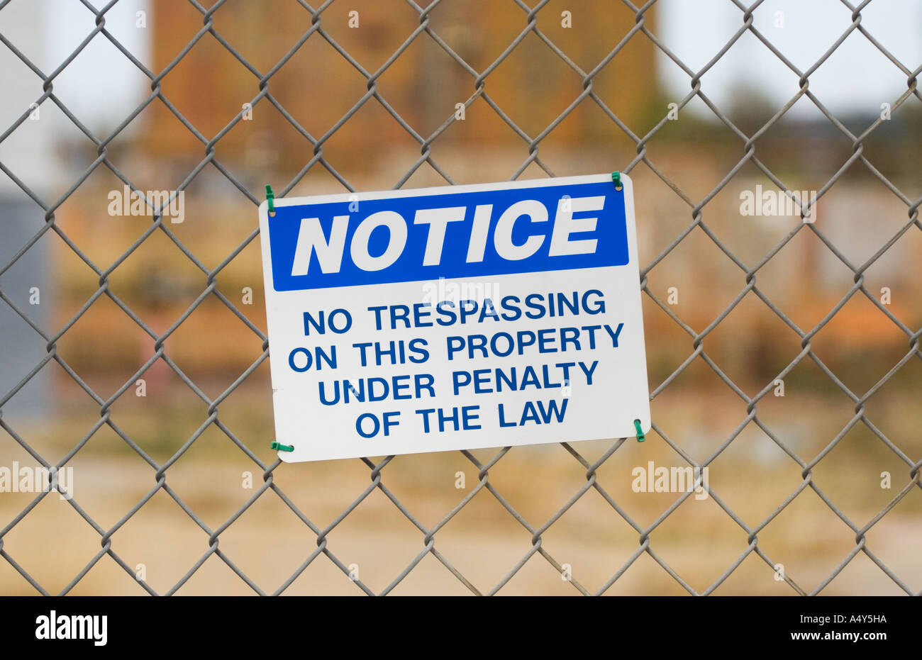 Warning notice on chain link fence Stock Photo - Alamy