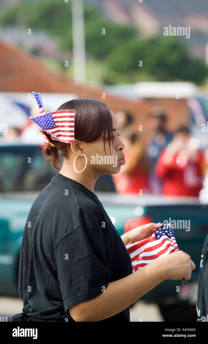 Woman with US flags watching parade for soldiers Stock Photo - Alamy