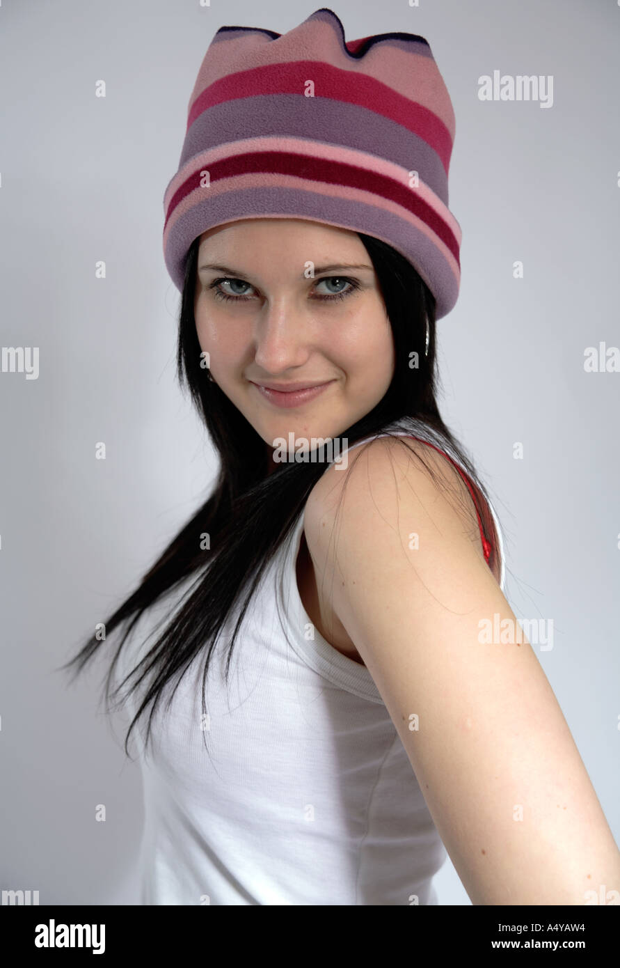 Young woman aged 16 with woolly hat stripey shades of purple looking ...