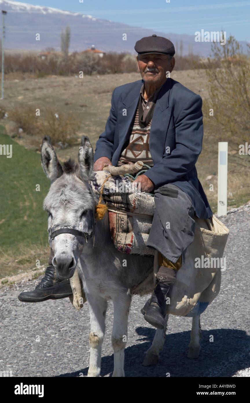 Turkish Man Riding donkey on road in Cappadocia region of Turkey Stock ...