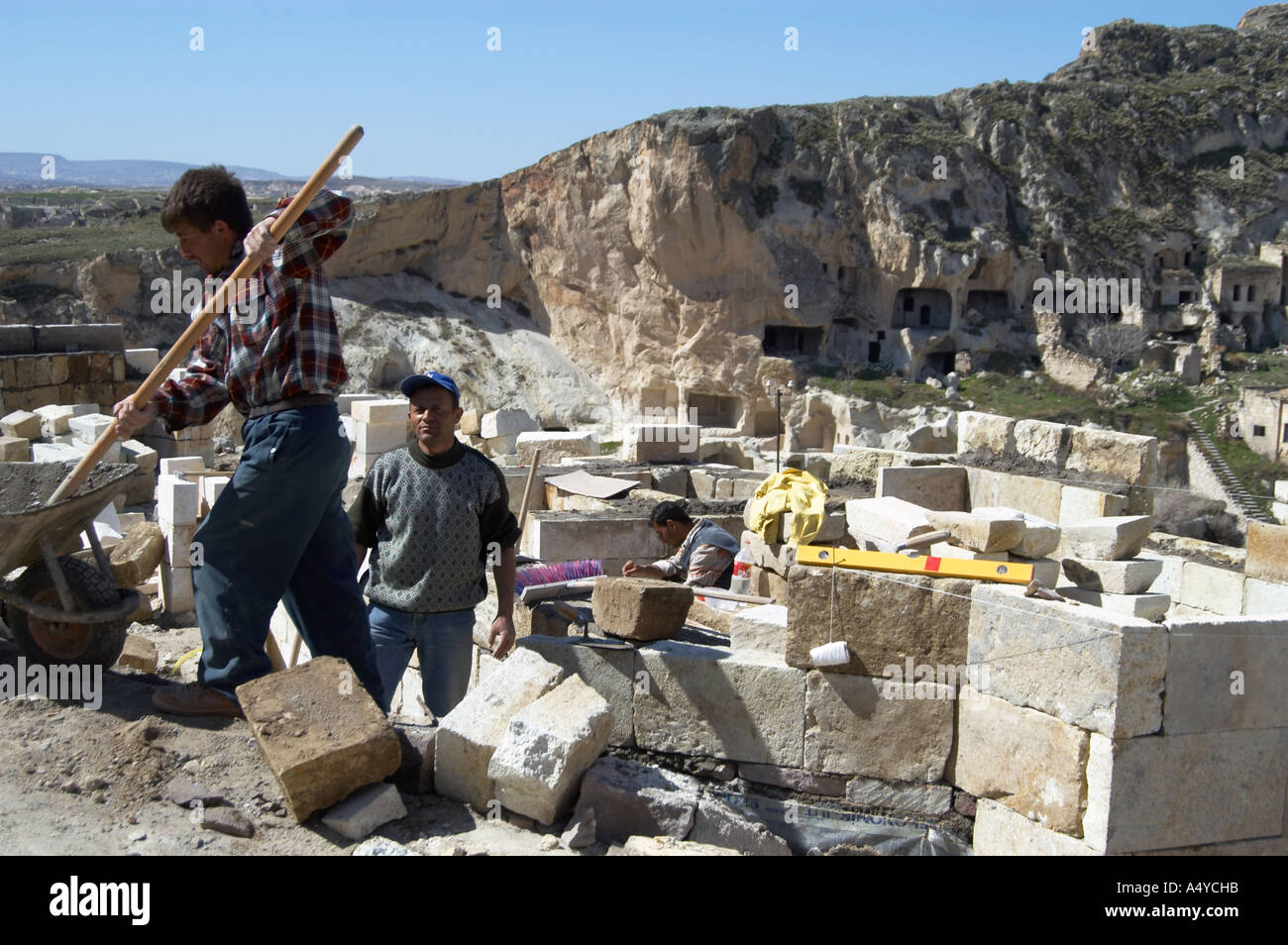 Stone masons at work building structure in Cappadocia Turkey Stock ...