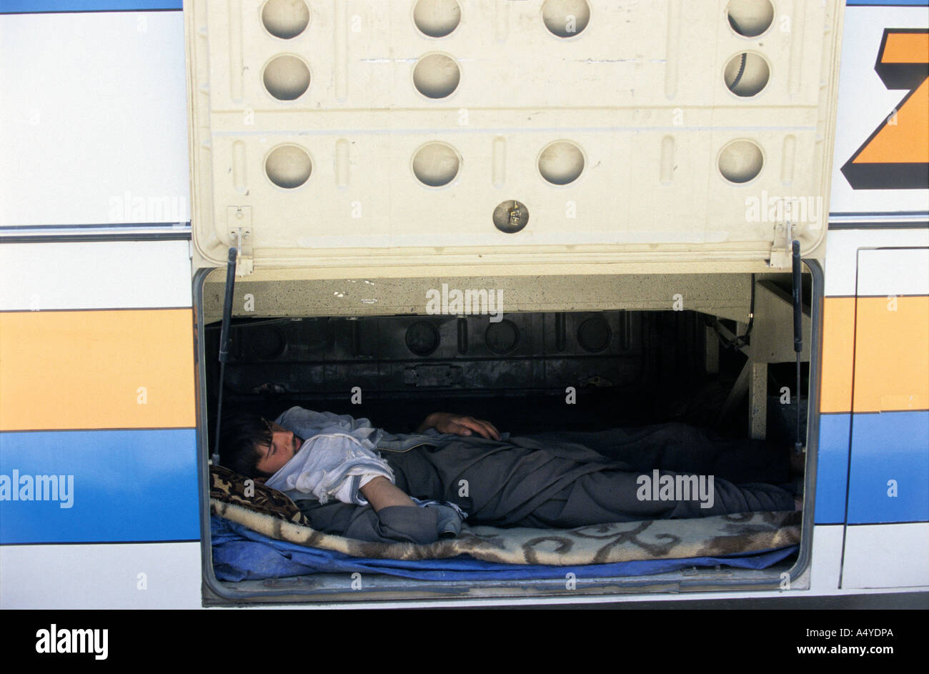 Kabul, a driver sleeping in the trunck of the bus Stock Photo - Alamy