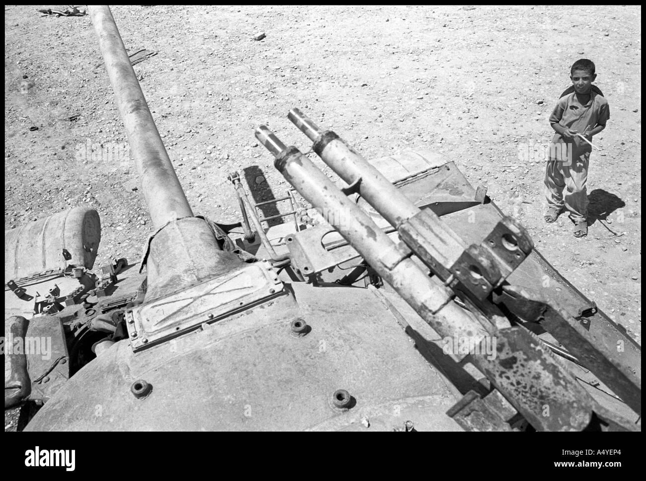 Little boy infront of bombed tank, Kirkuk Stock Photo - Alamy