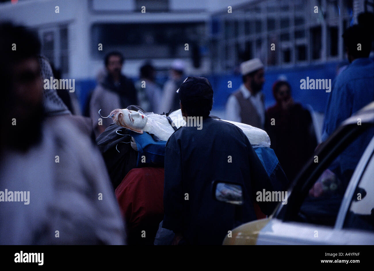 Kabul, a street vendor pushing its trolley loaded with clothing for ...