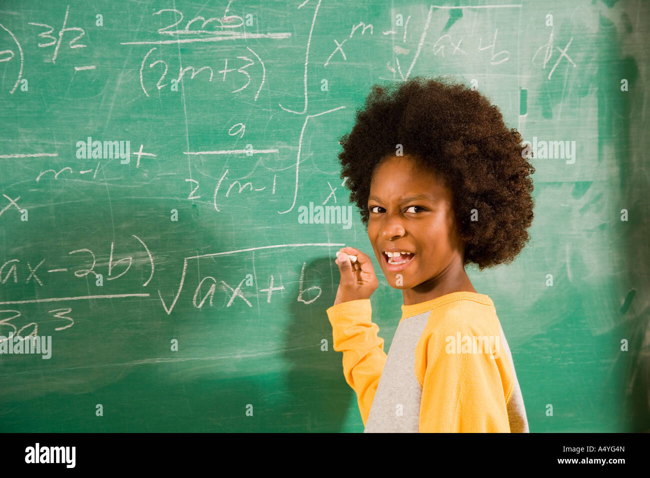 Portrait of boy writing on blackboard Stock Photo - Alamy