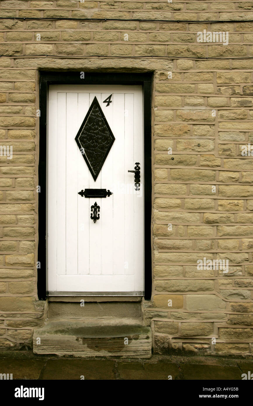 Typical English home wooden door white number four 4 chilly rainy ...