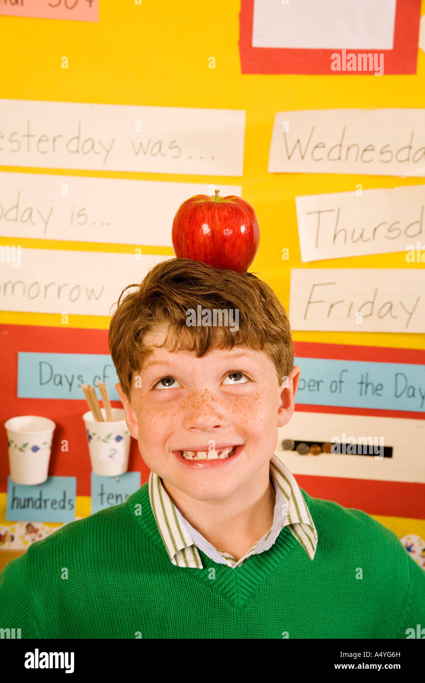 Boy with apple on head in classroom Stock Photo - Alamy