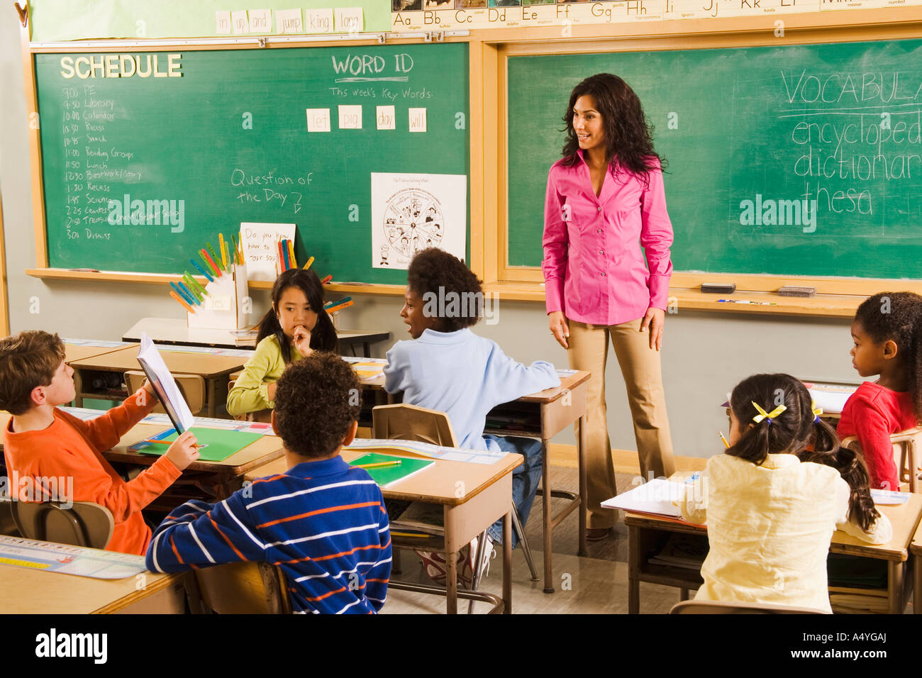 Student holding up work in classroom Stock Photo - Alamy