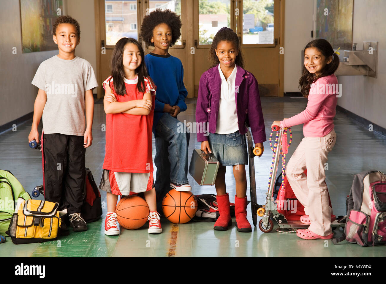 Group of students with sports equipment in hallway Stock Photo - Alamy