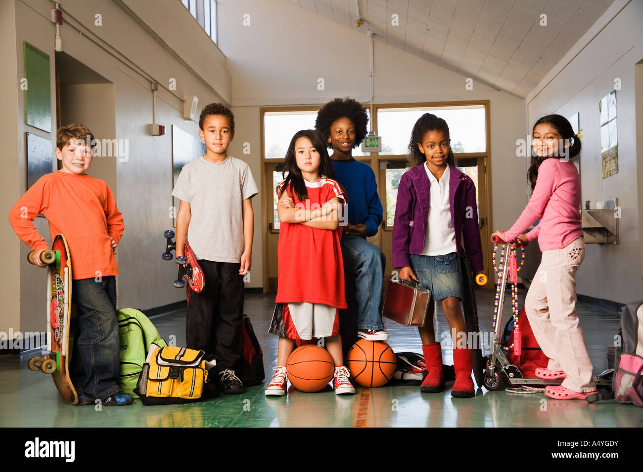 Group of students with sports equipment in hallway Stock Photo - Alamy