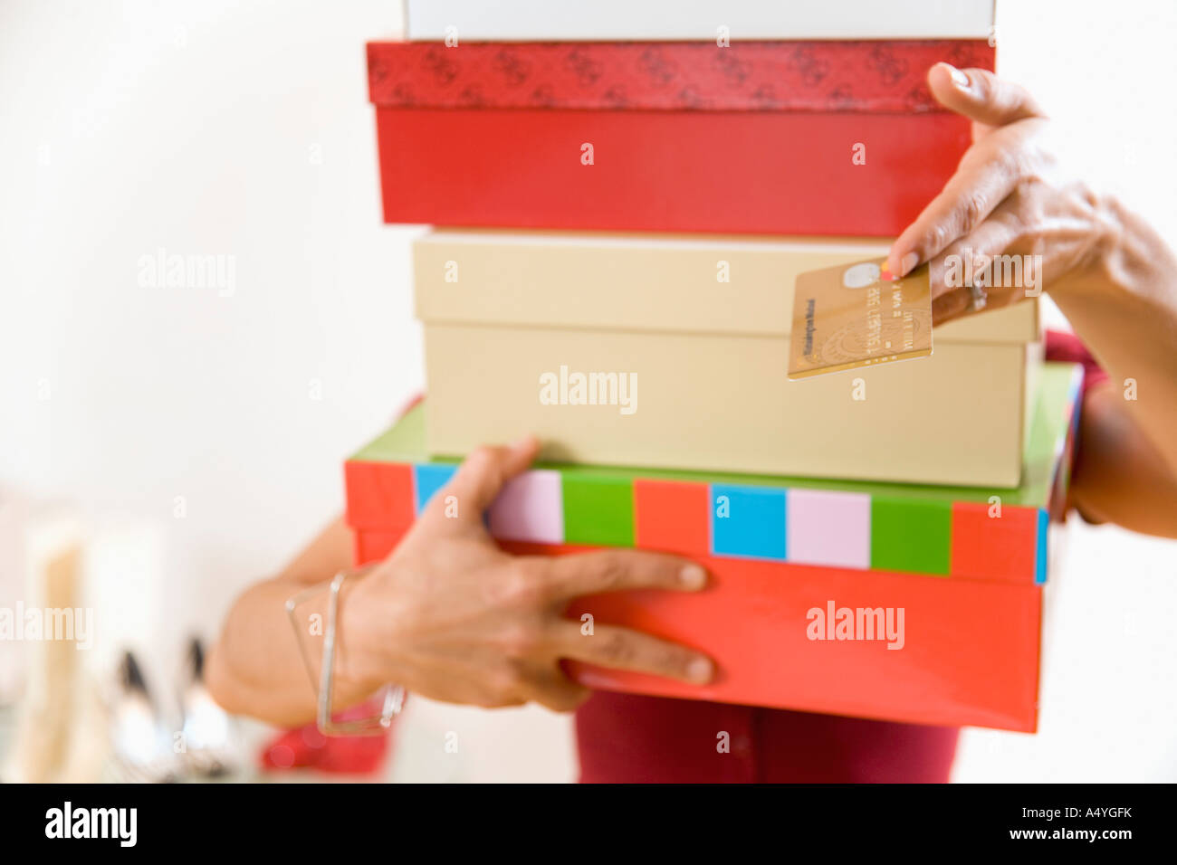 Woman paying for stack of items at boutique Stock Photo - Alamy