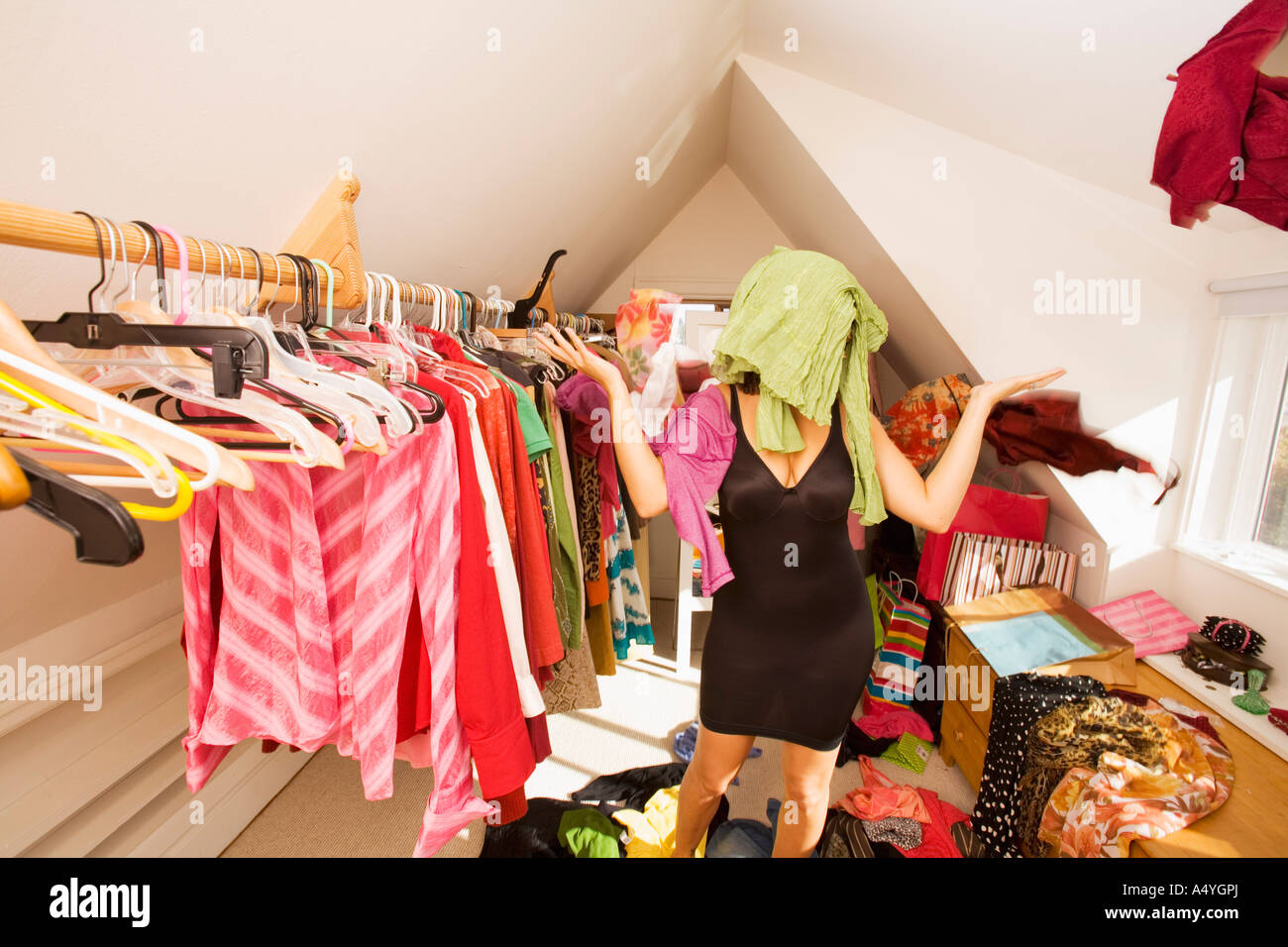 Woman looking for something to wear in closet Stock Photo - Alamy