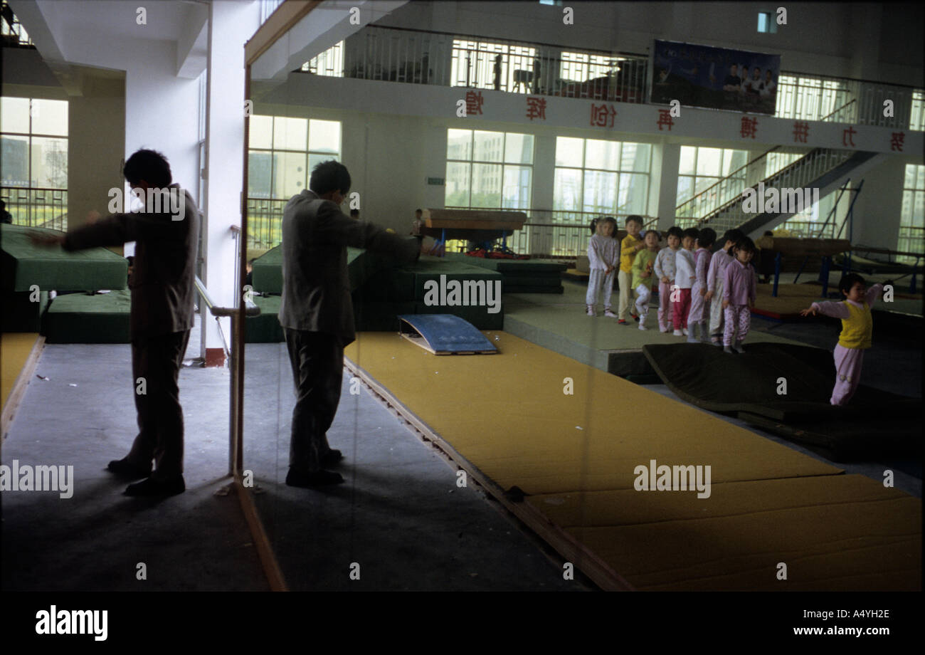 a father instructs his daughter who practices gymnastics at the Li ...