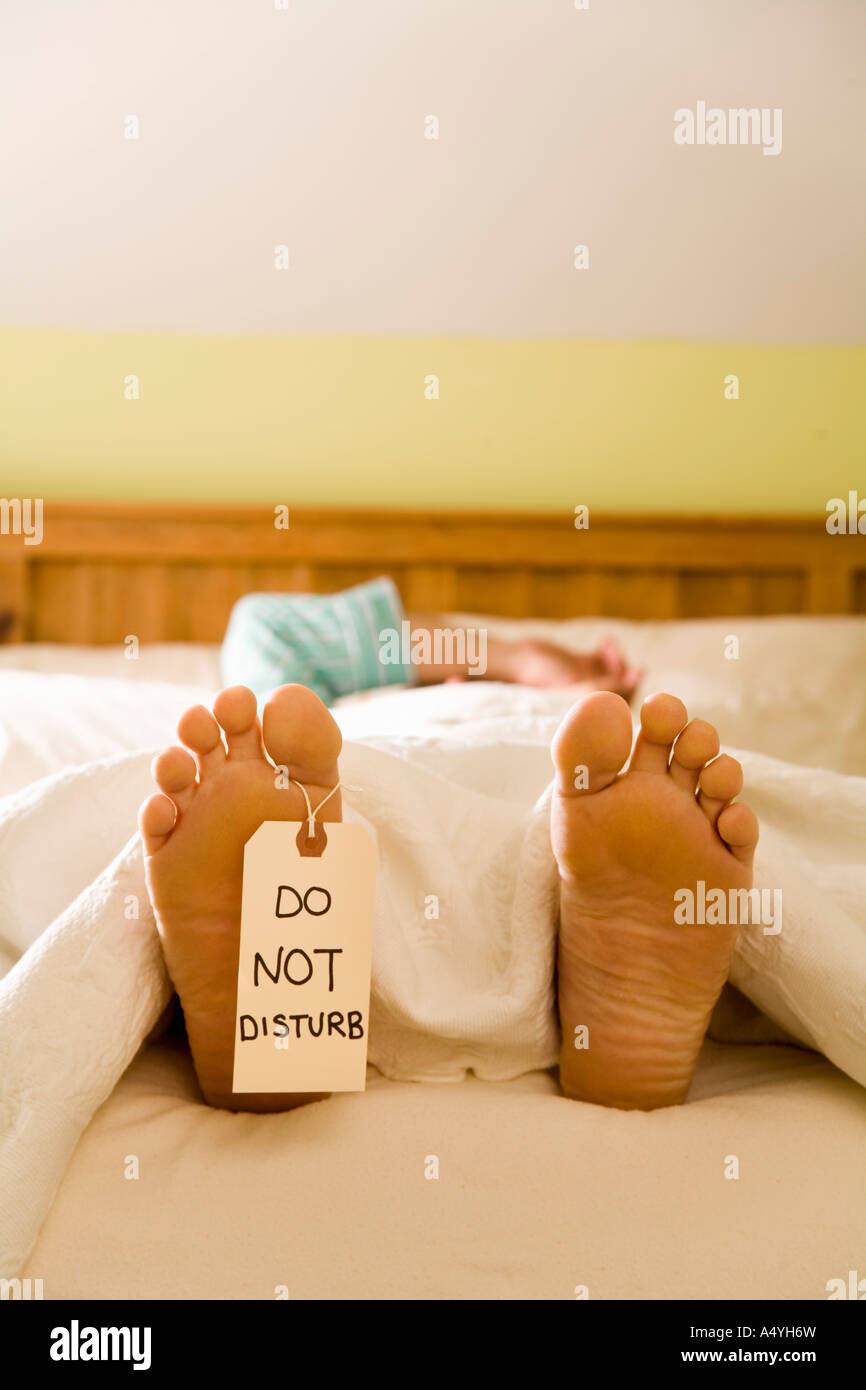 Bare feet with Do Not Disturb sign Stock Photo - Alamy