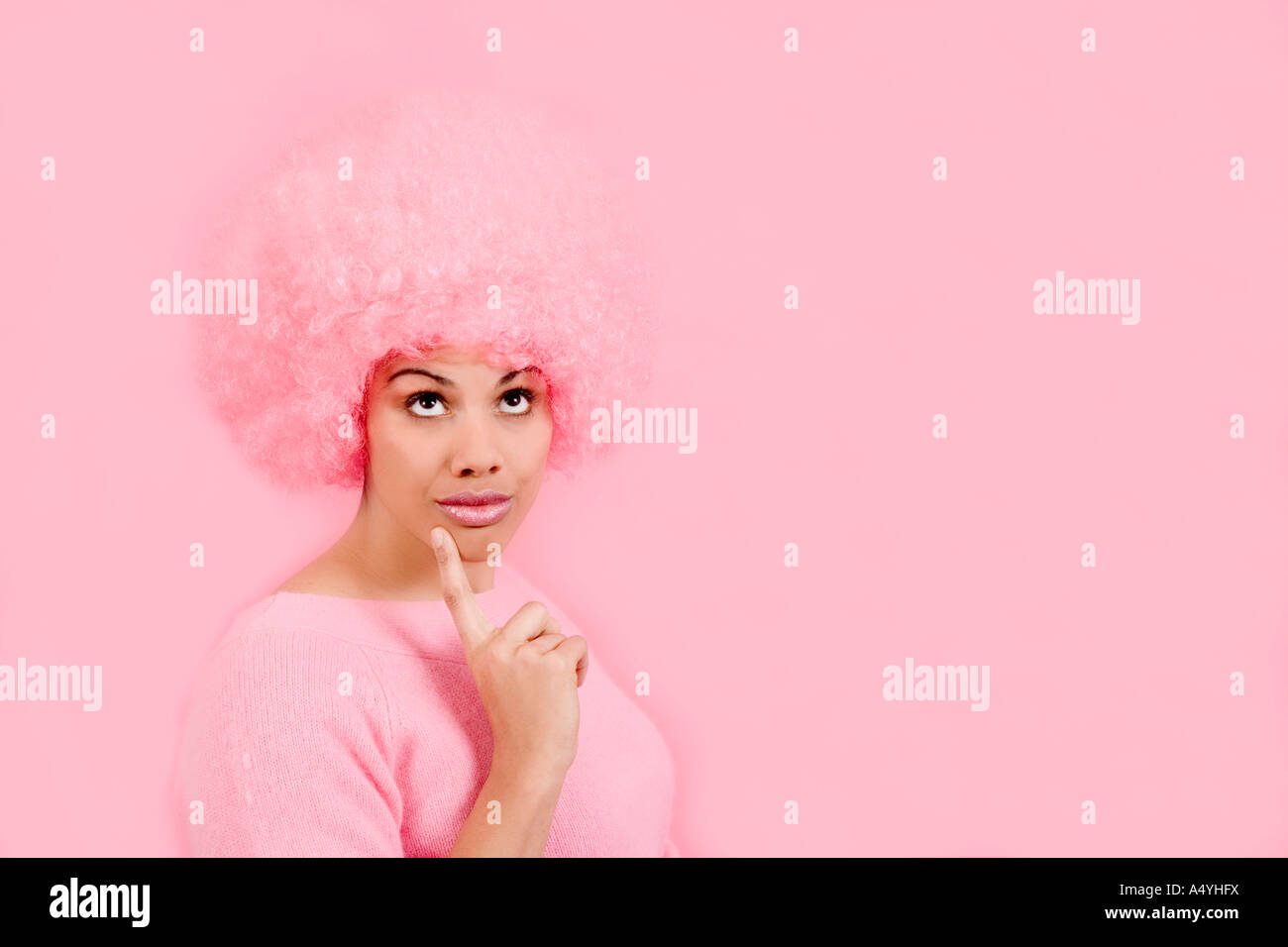 Woman wearing pink wig and thinking Stock Photo - Alamy