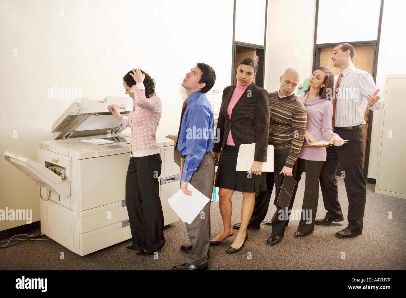 Businesspeople on line to use photocopy machine Stock Photo - Alamy