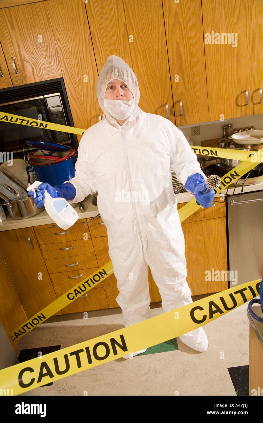 Man wearing coveralls to clean dirty kitchen Stock Photo - Alamy