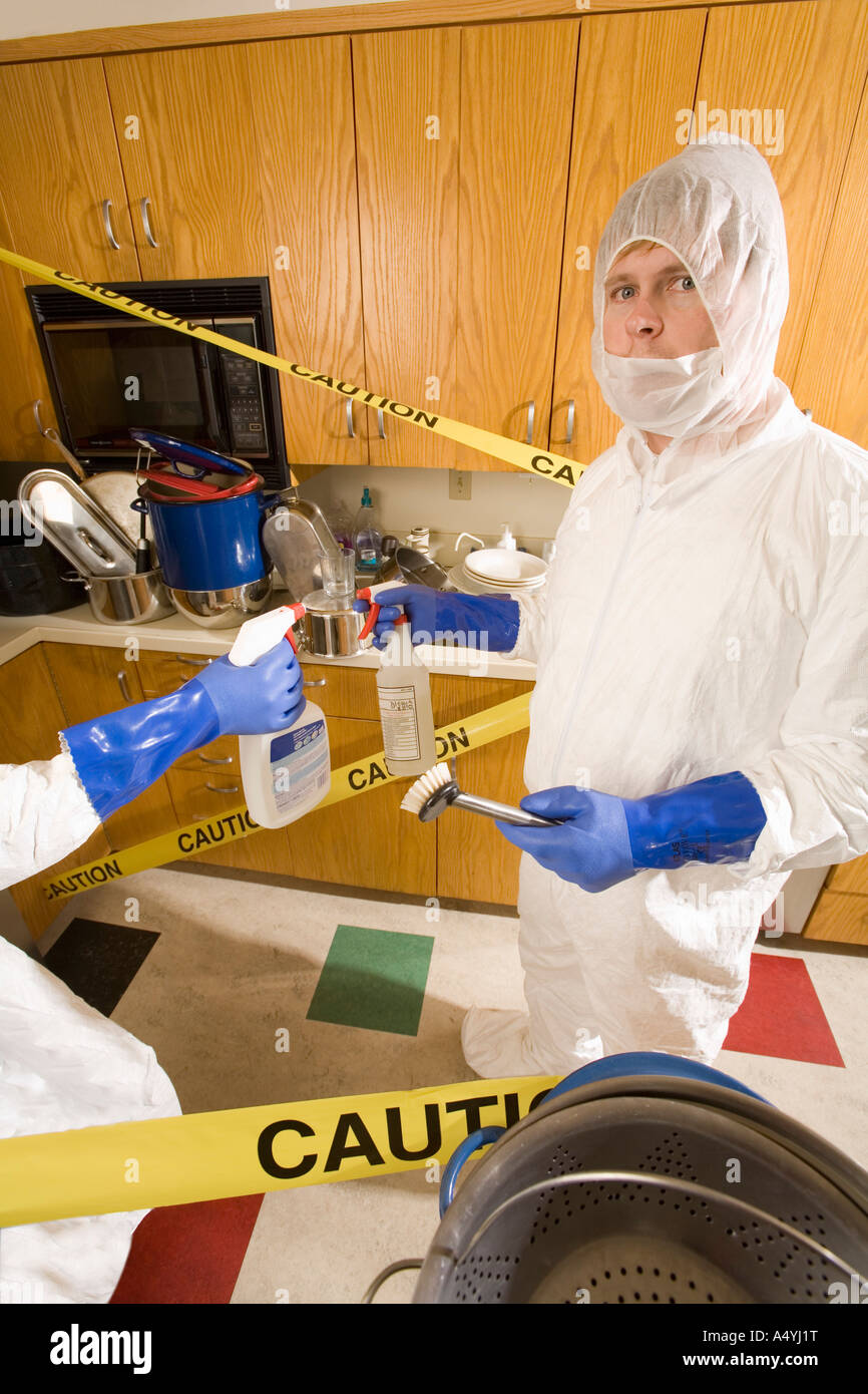 Man wearing coveralls to clean dirty kitchen Stock Photo - Alamy