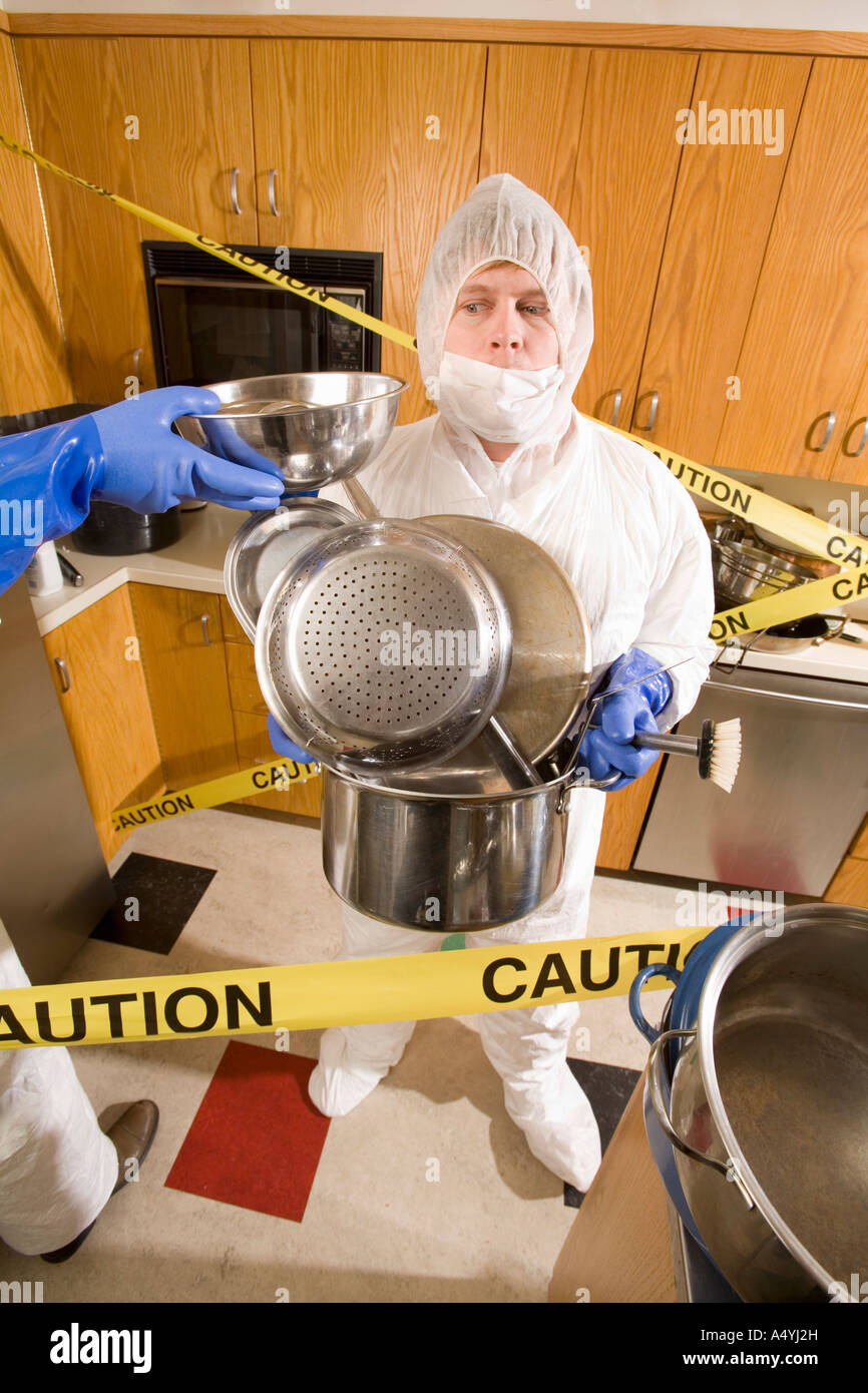 Man wearing coveralls and holding pots in dirty kitchen Stock Photo - Alamy