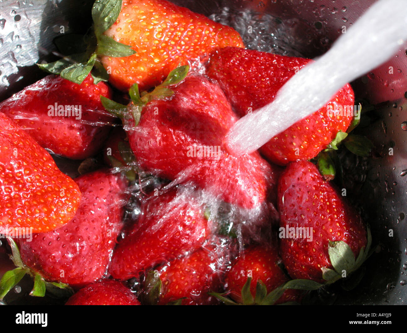A waterjet on strawberrys Stock Photo - Alamy