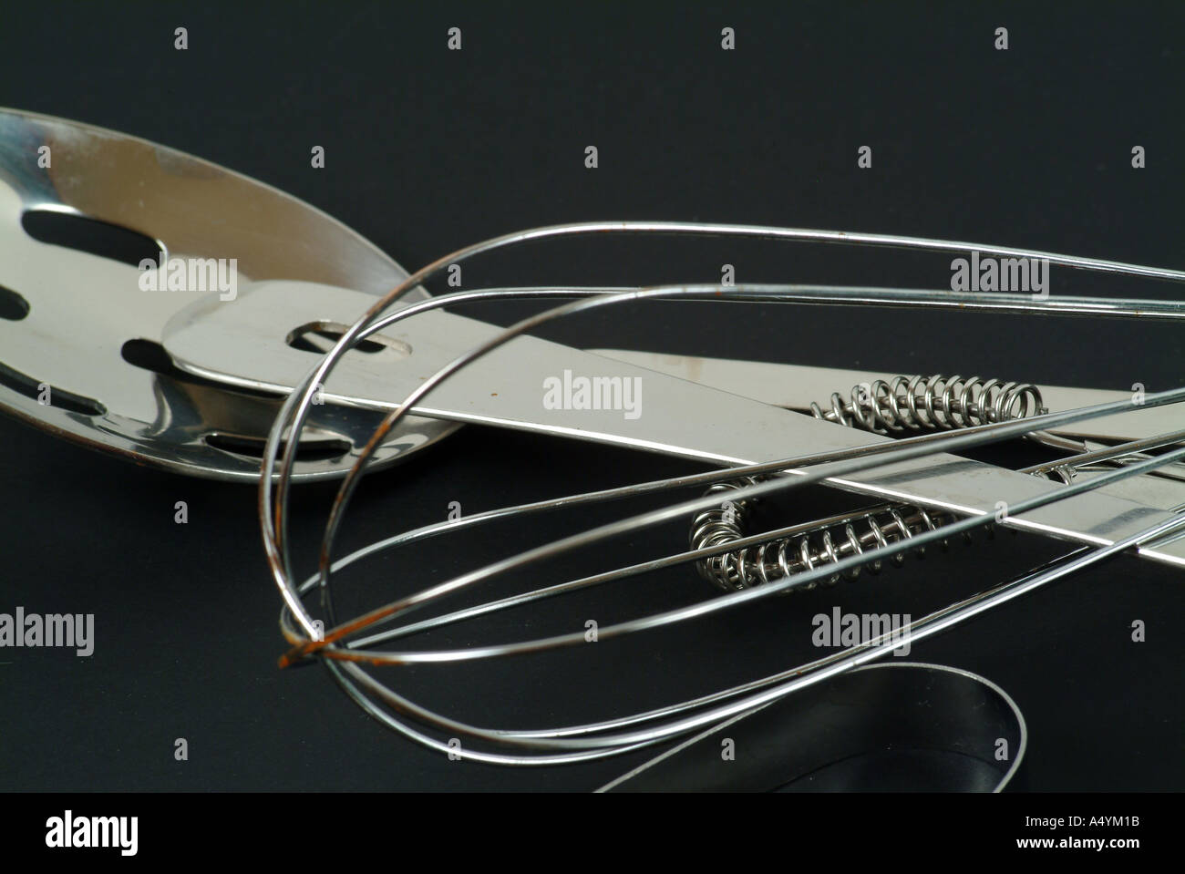 Stainless steel kitchen utensils on a matt black background Stock Photo ...