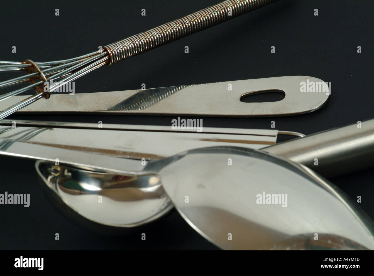 Stainless steel kitchen utensils on a matt black background Stock Photo ...