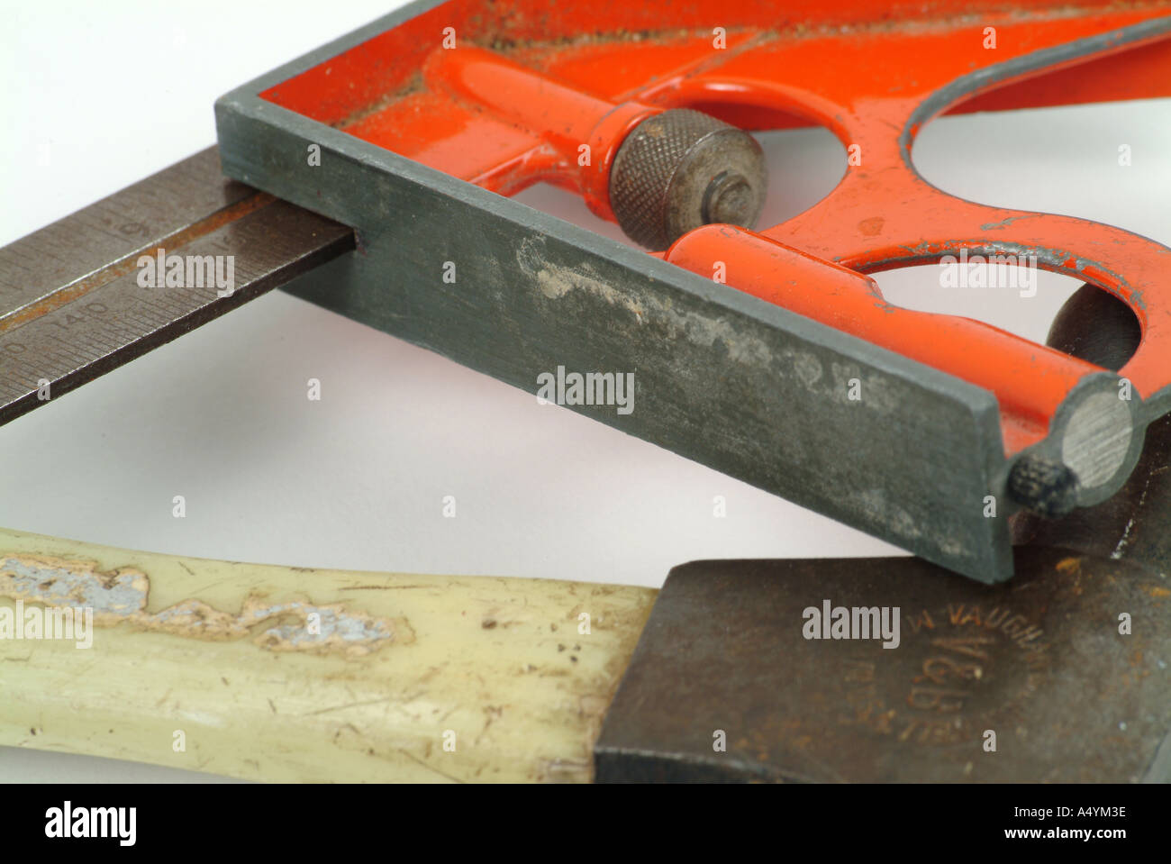 a set square and hammer thrown together on a white background Stock ...