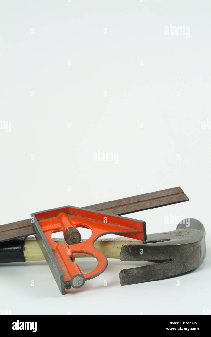 a set square and hammer thrown together on a white background Stock ...