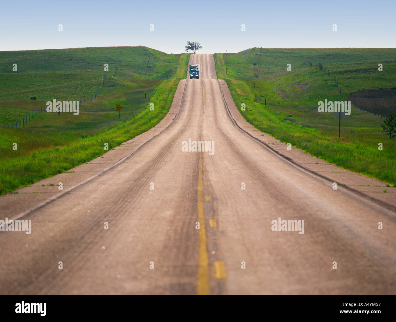 Tractor trailer truck rig on two lane U S Highway 20 through the ...