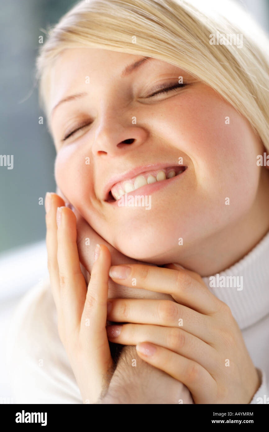 woman with her partners hands touching her face Stock Photo - Alamy