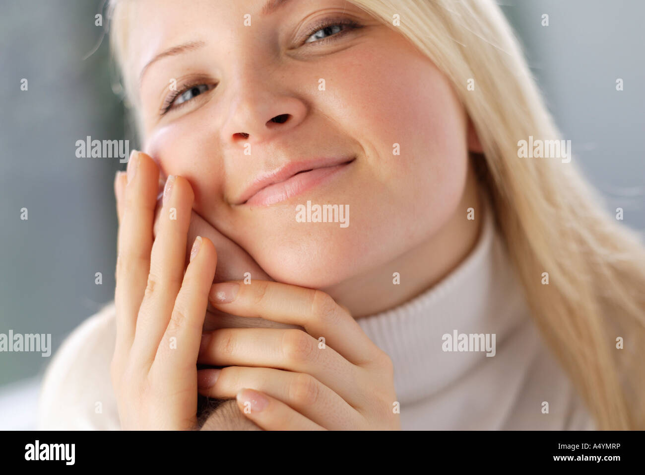woman with her partners hands touching her face Stock Photo - Alamy
