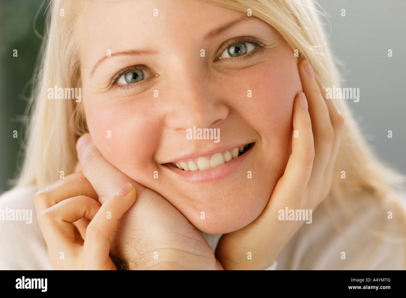woman with her partners hands touching her face Stock Photo - Alamy