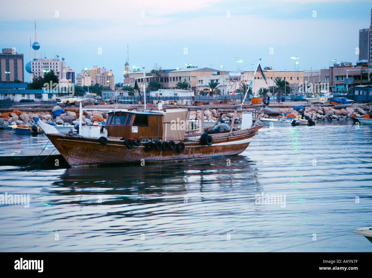 Kuwait City Kuwait Dhow Leaving Harbour At Dusk Stock Photo - Alamy
