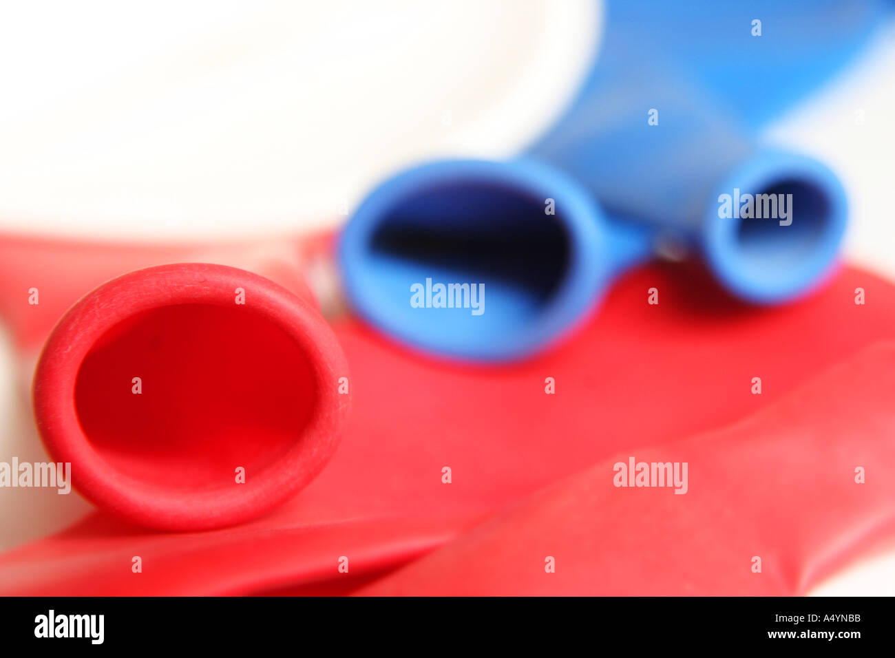 Colourful abstract image of un inflated balloons with the round opening ...