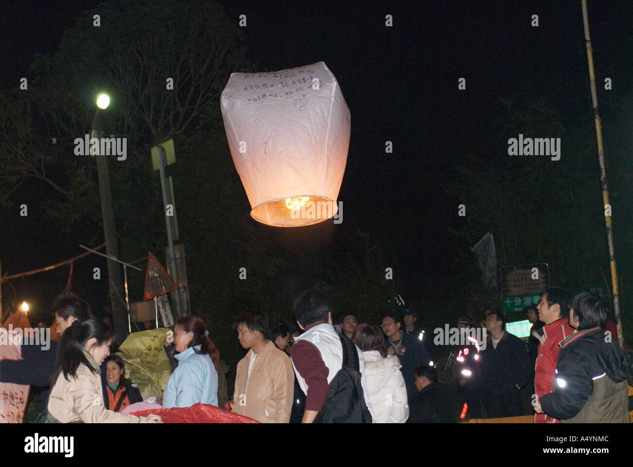 People Launching Chinese Paper Floating Lantern In Sky Heavenly Lantern ...