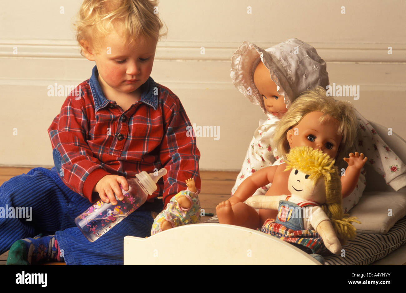 toddler playing with dolls Stock Photo - Alamy
