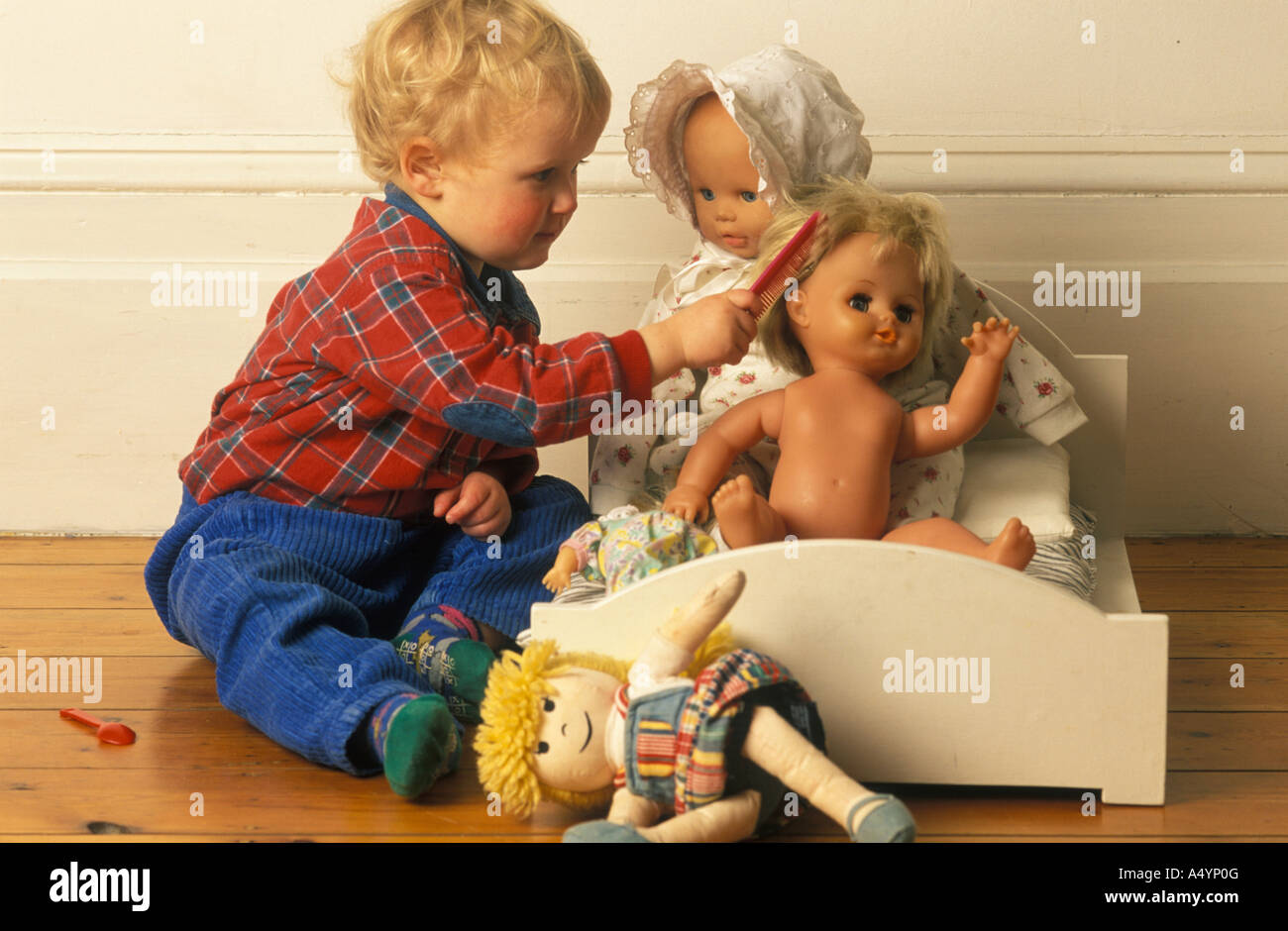 toddler playing with dolls Stock Photo - Alamy