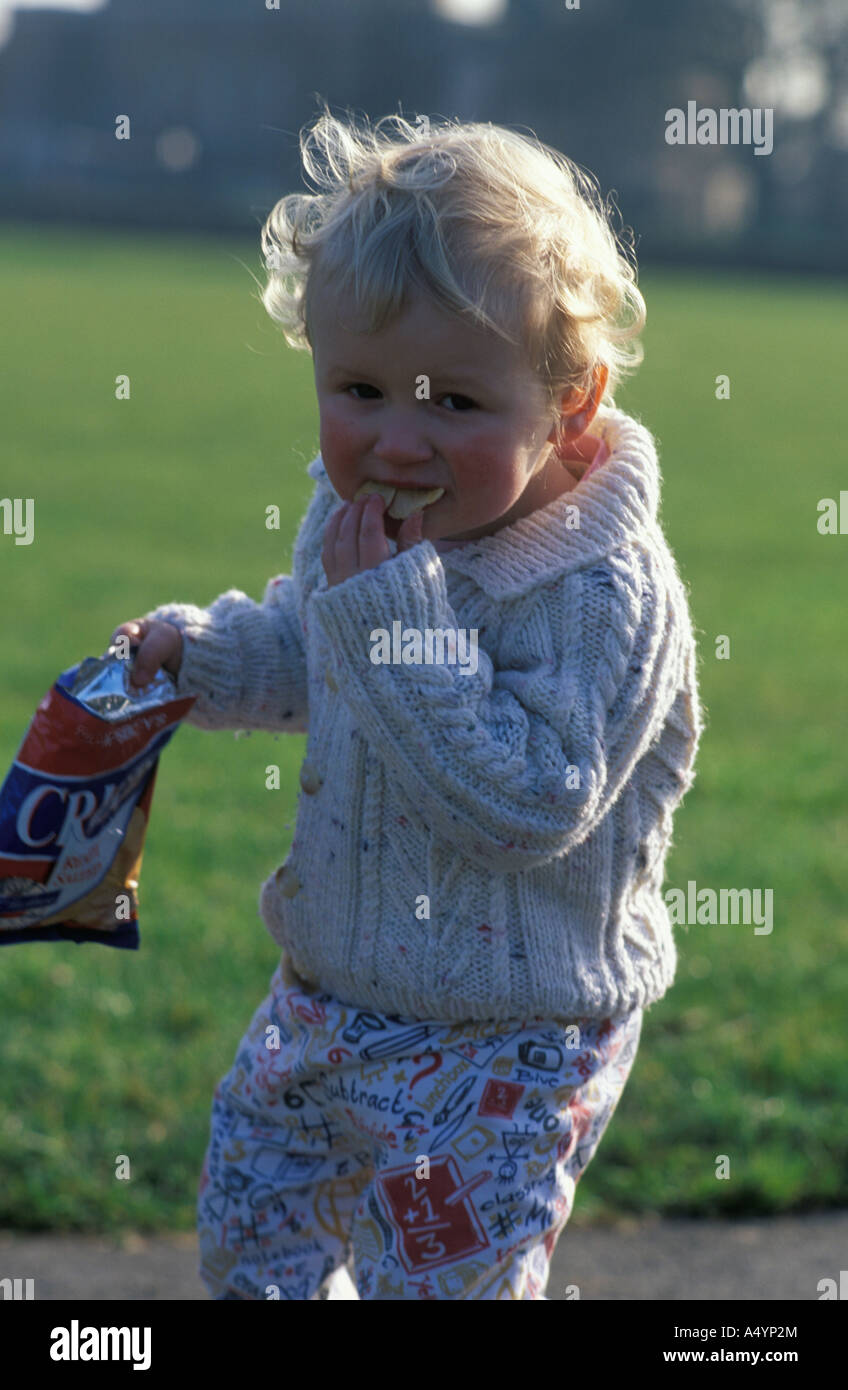 toddler eating bag of crisps Stock Photo - Alamy