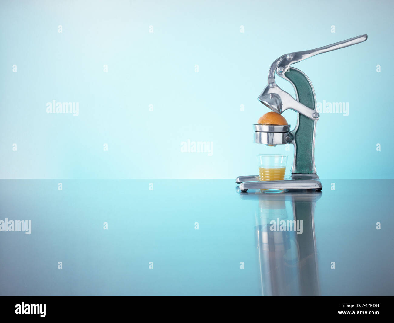 Italian juicer on brushed steel background pressing an orange into a ...