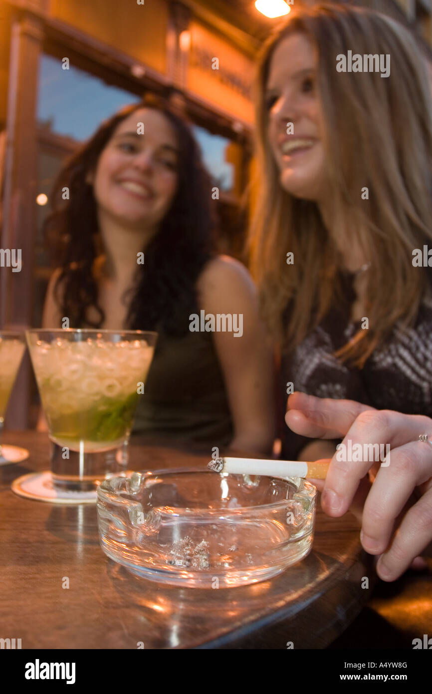 Two young women relaxing in a bar Stock Photo - Alamy