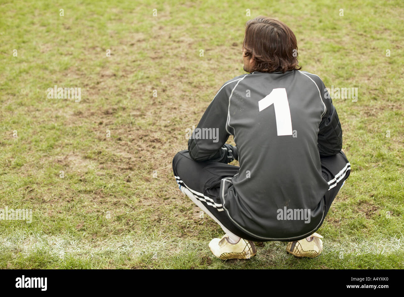 Crouching male figure hi-res stock photography and images - Alamy