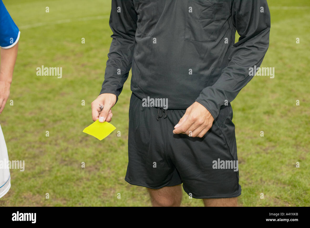Referee giving yellow card Stock Photo - Alamy