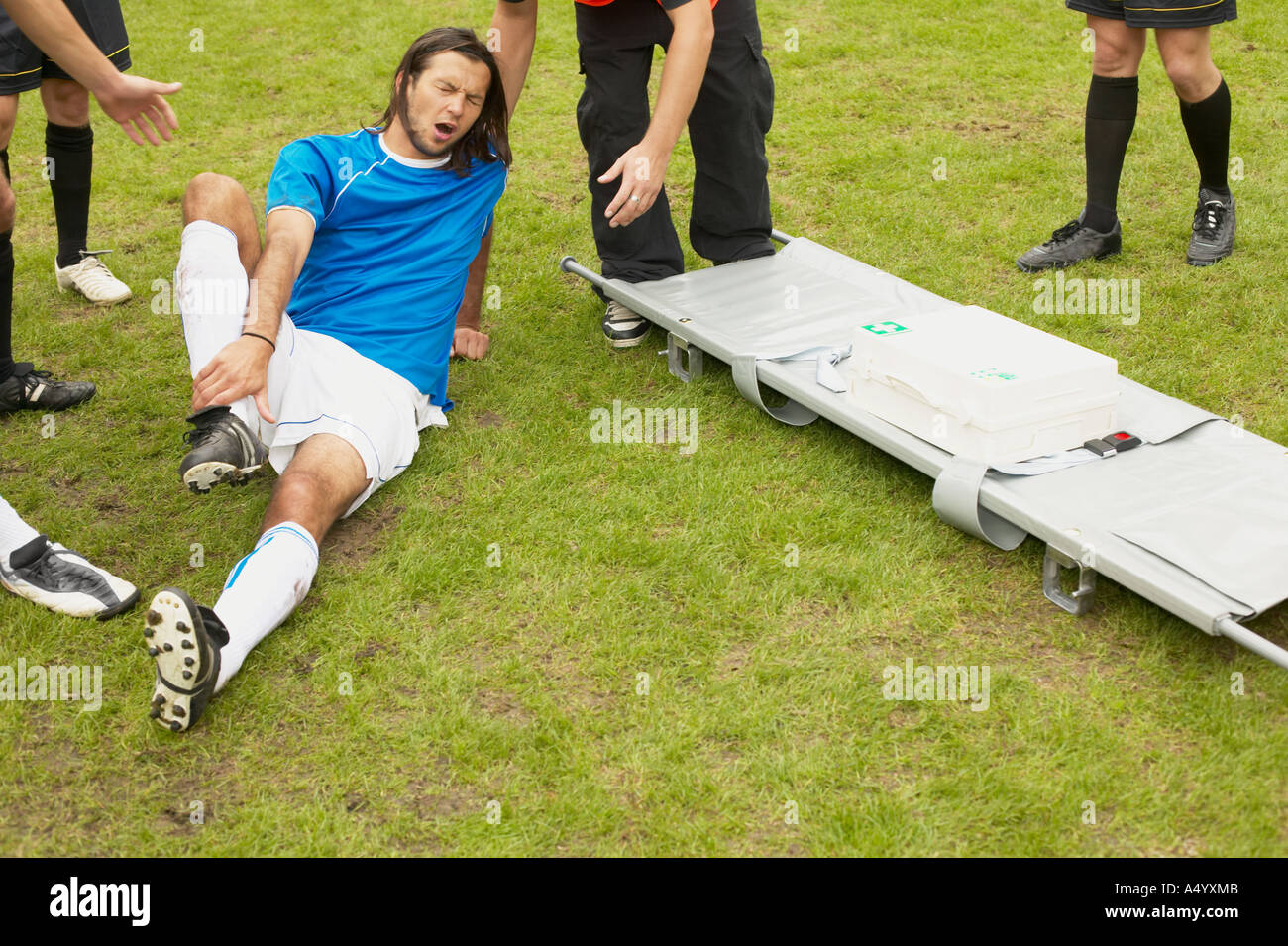 Injured footballer and stretcher hi-res stock photography and images ...