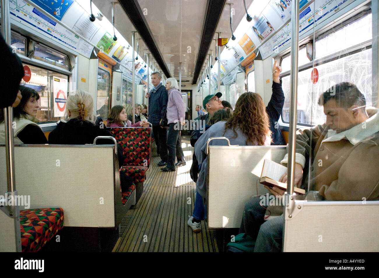Commuters on a Tube train London England Stock Photo - Alamy