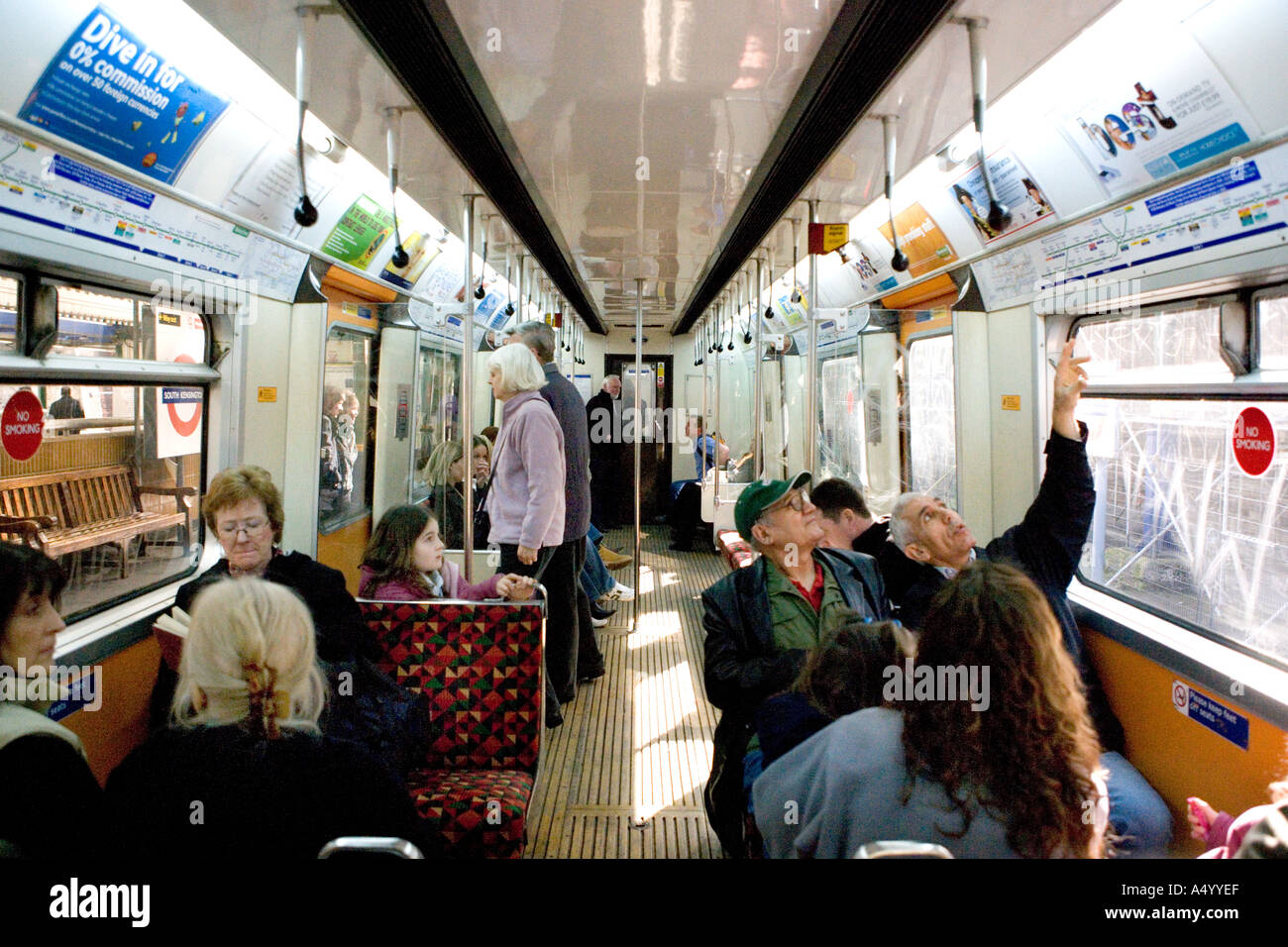 Commuters on a Tube train London England Stock Photo - Alamy