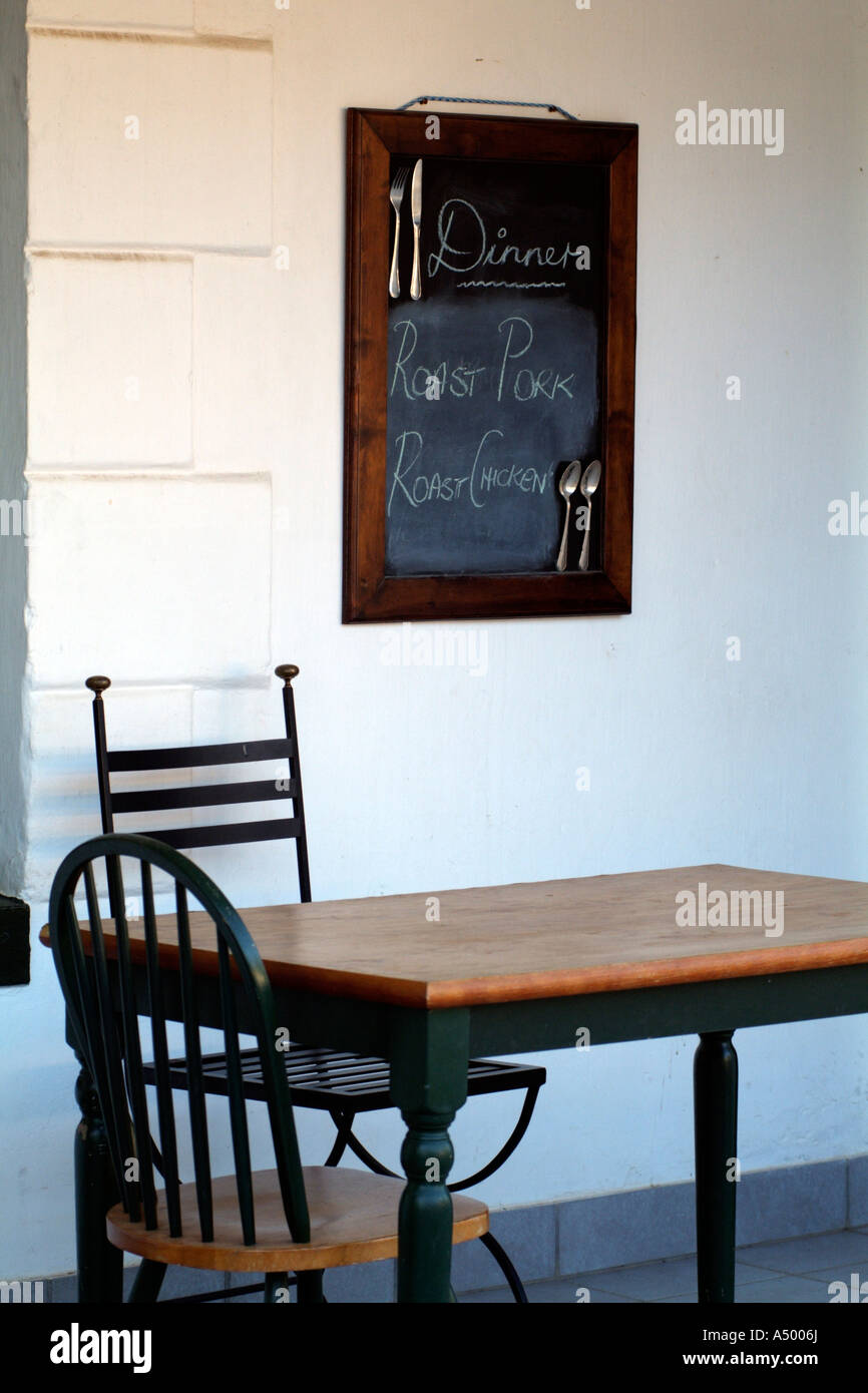 Dinner menu board on display outside a catering establishment in South ...