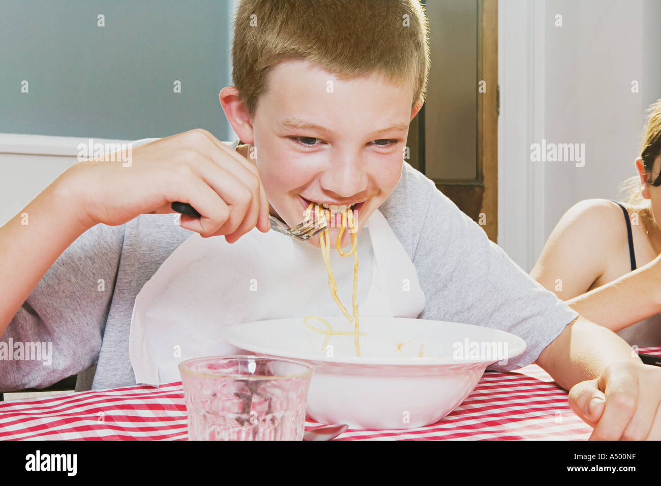 Boy eating spaghetti Stock Photo - Alamy