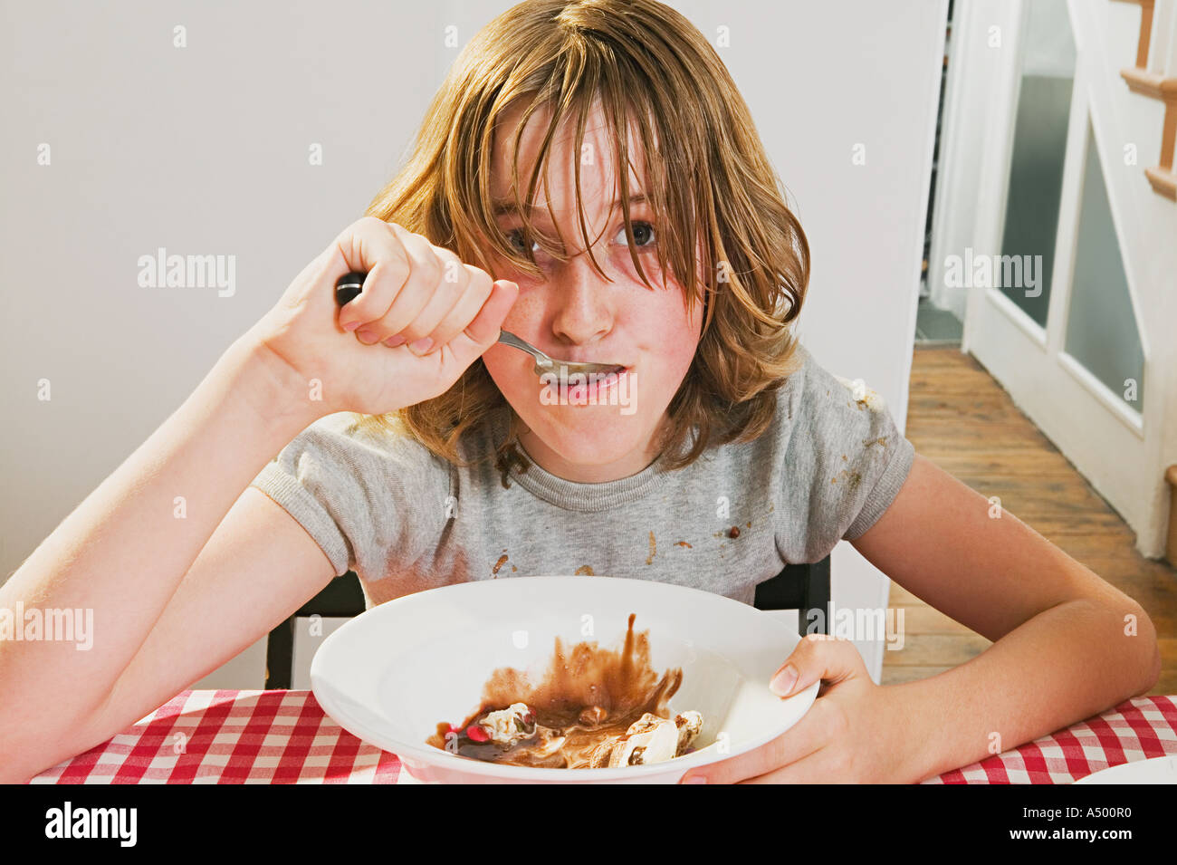Girl eating messily Stock Photo - Alamy