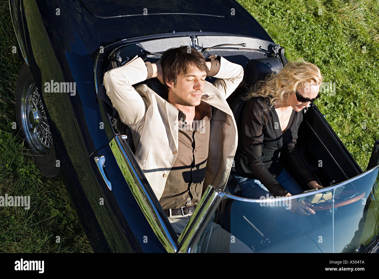 Couple in a convertible Stock Photo - Alamy