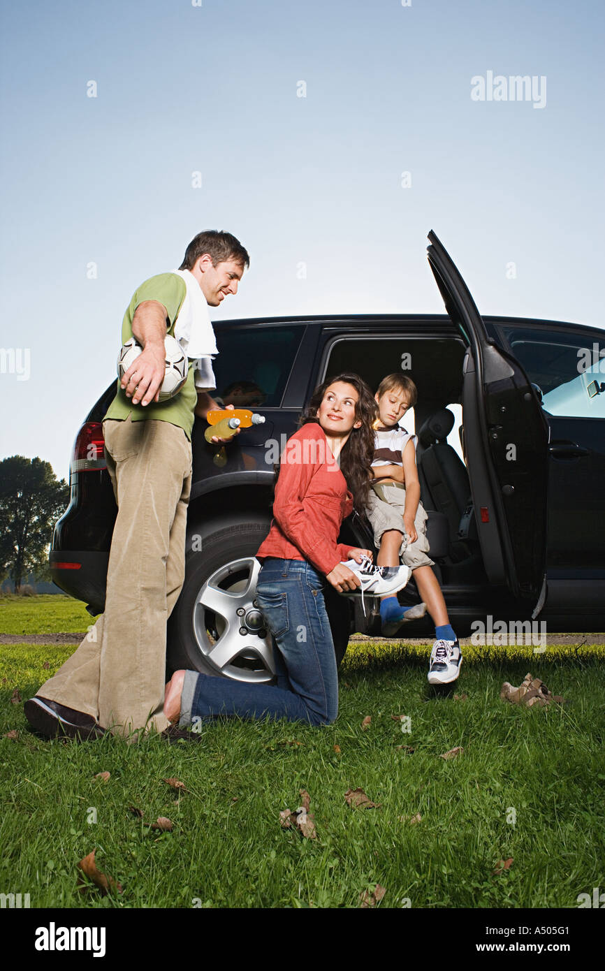 Family getting out of car Stock Photo - Alamy